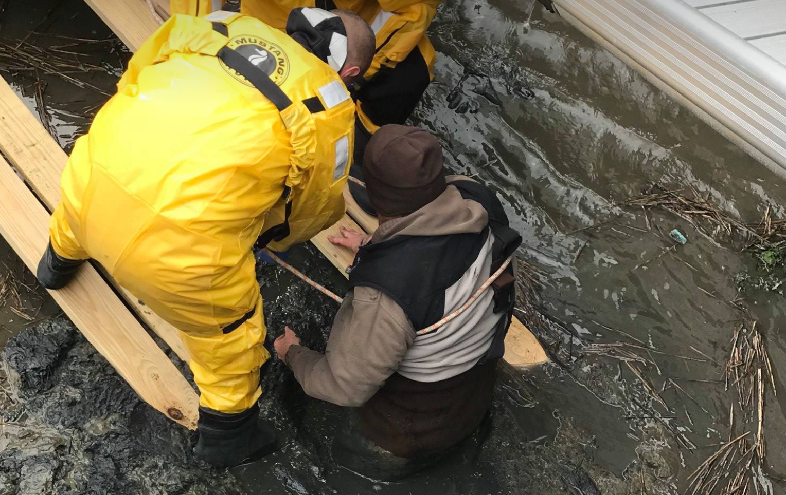 Firefighters rescue man stuck in mud amid rapidly rising tide - WHYY